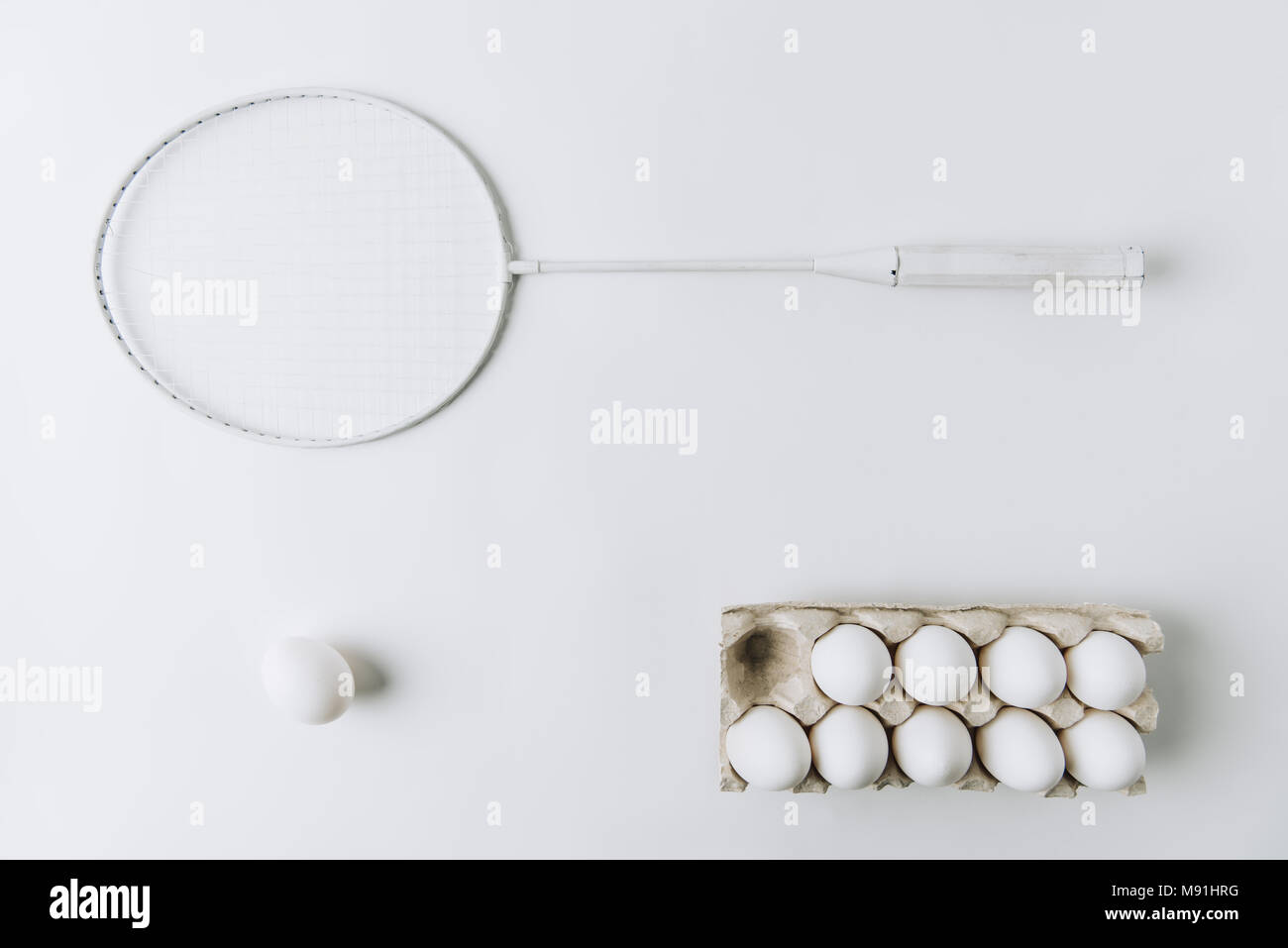 white egg on white background with another white eggs in carton and ...