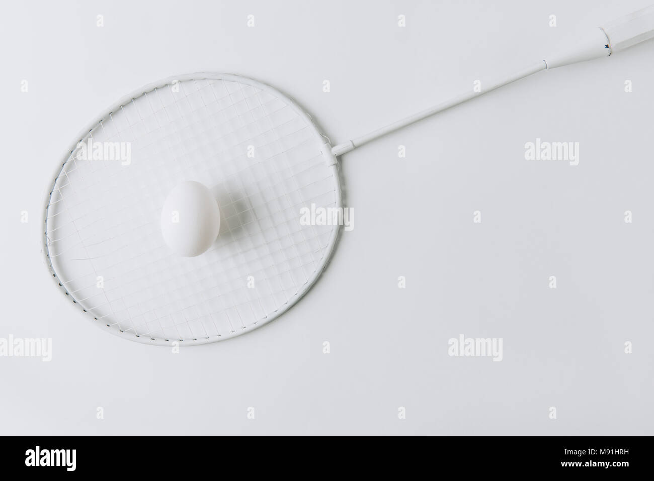 white egg laying over tennis racket Stock Photo - Alamy