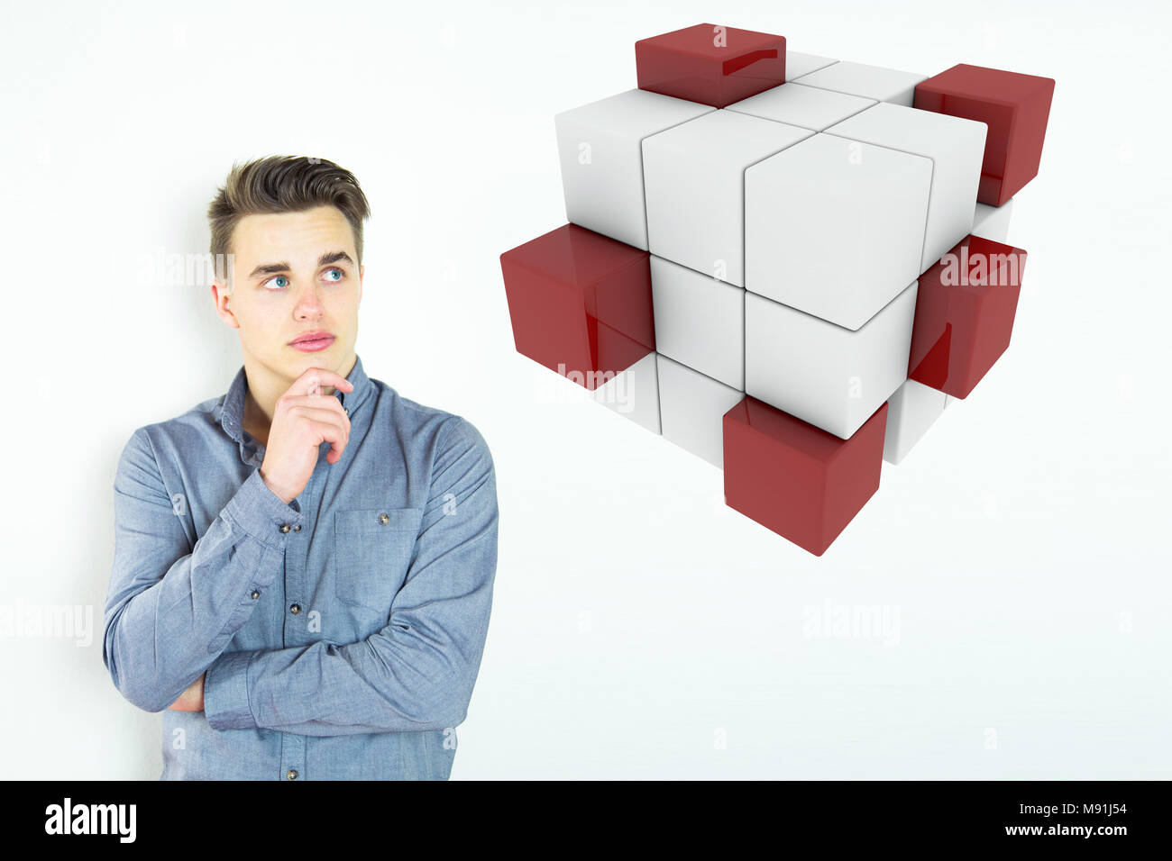 Blue eyed boy thinking with cubes problem Stock Photo - Alamy