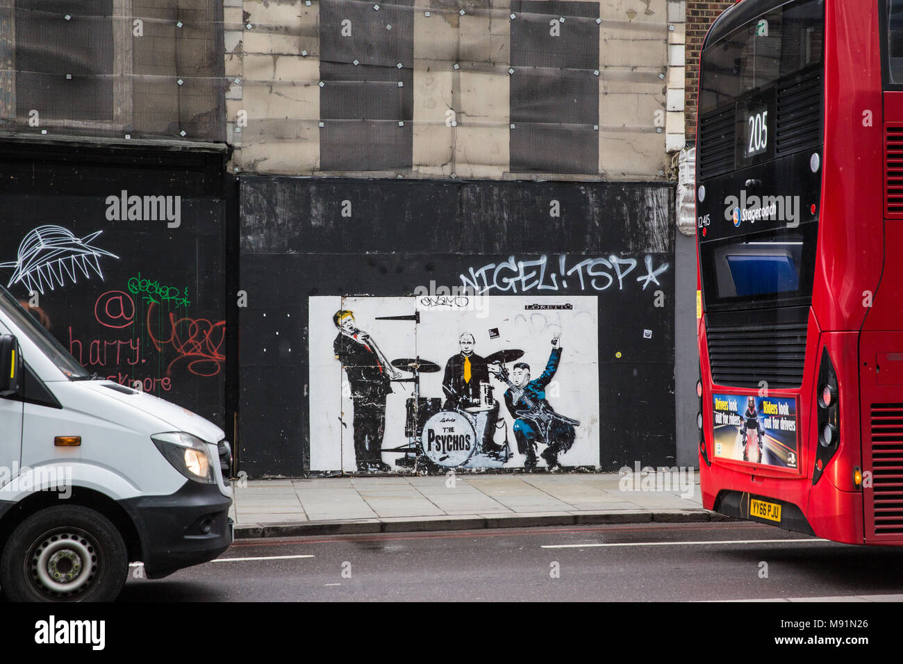 London, UK. 17th March, 2018. Vehicles pass in front of street art by ...