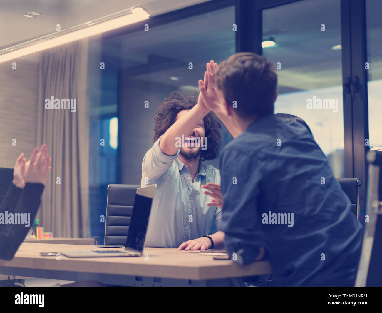 Group of young business people looking happy while celebrating success ...