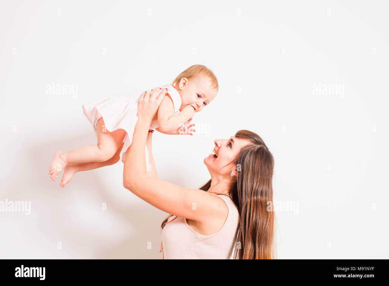 Toss baby with mom Stock Photo - Alamy