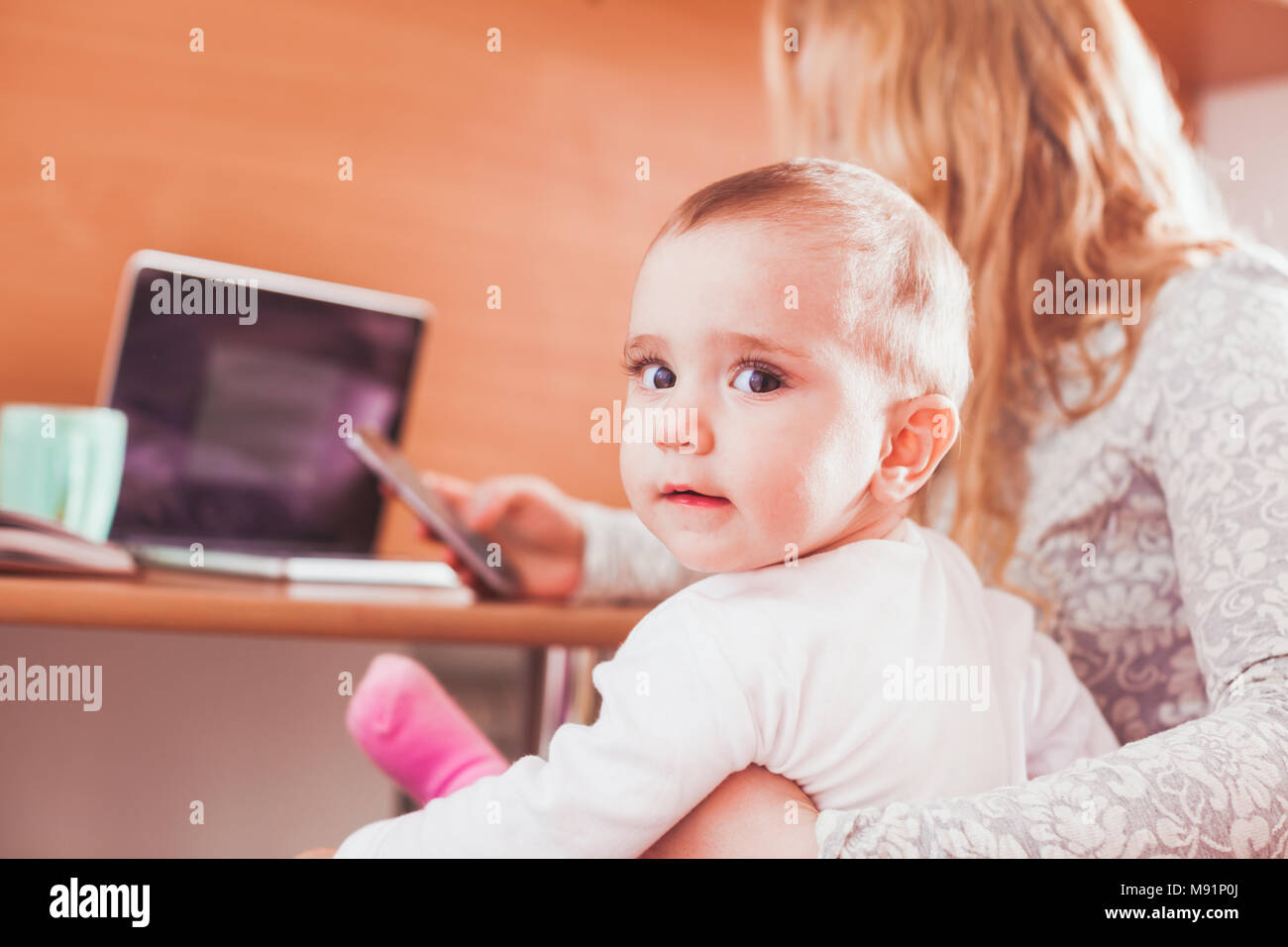 Baby with mom on work Stock Photo - Alamy