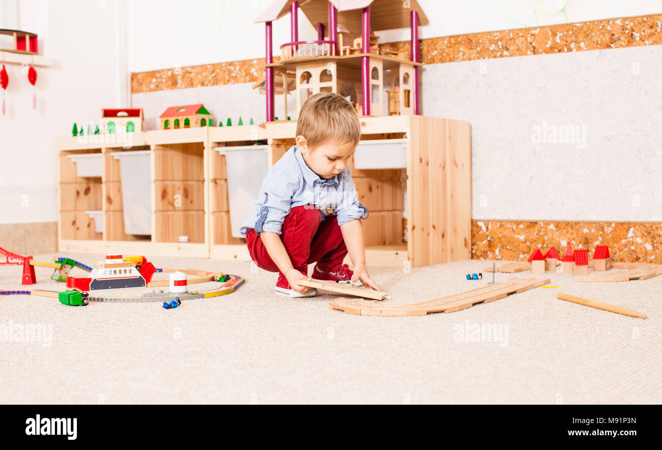 Boy plays with train Stock Photo - Alamy