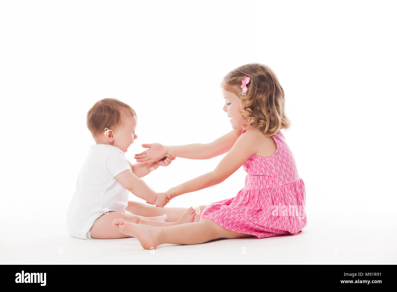 Two sisters isolated Stock Photo - Alamy