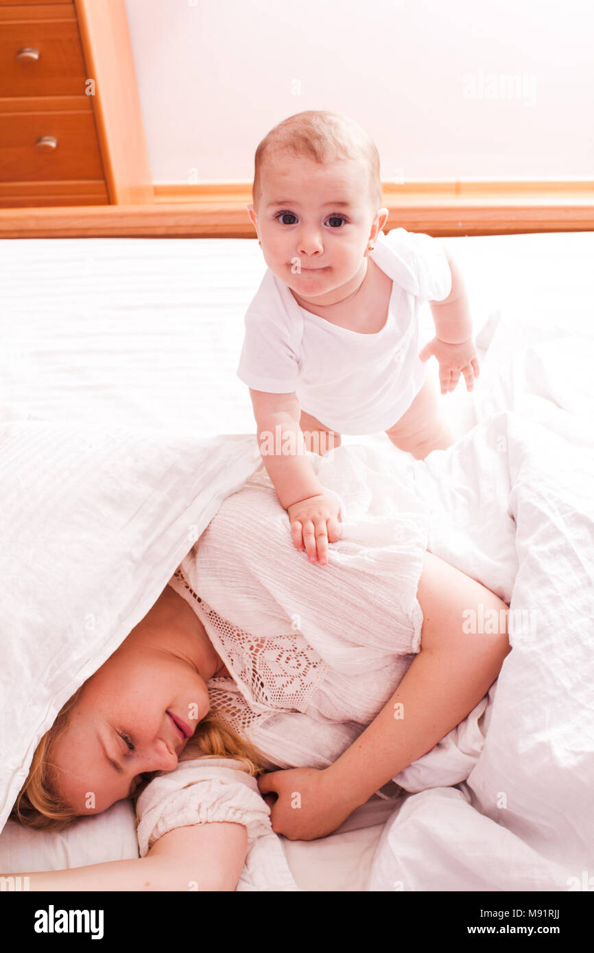 Baby wake up sleepy mom Stock Photo - Alamy
