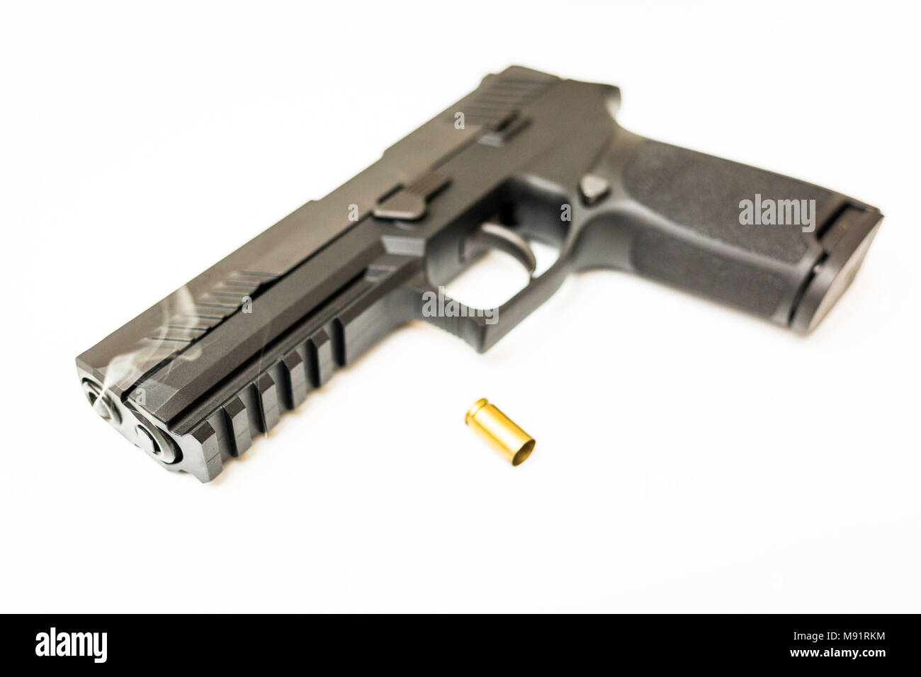 Handgun with ammo rounds and smoke coming out after a shoot Stock Photo ...