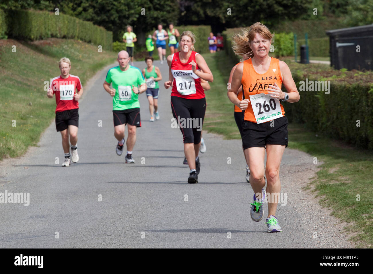 Runners on a country road competing in a 10km race Stock Photo - Alamy
