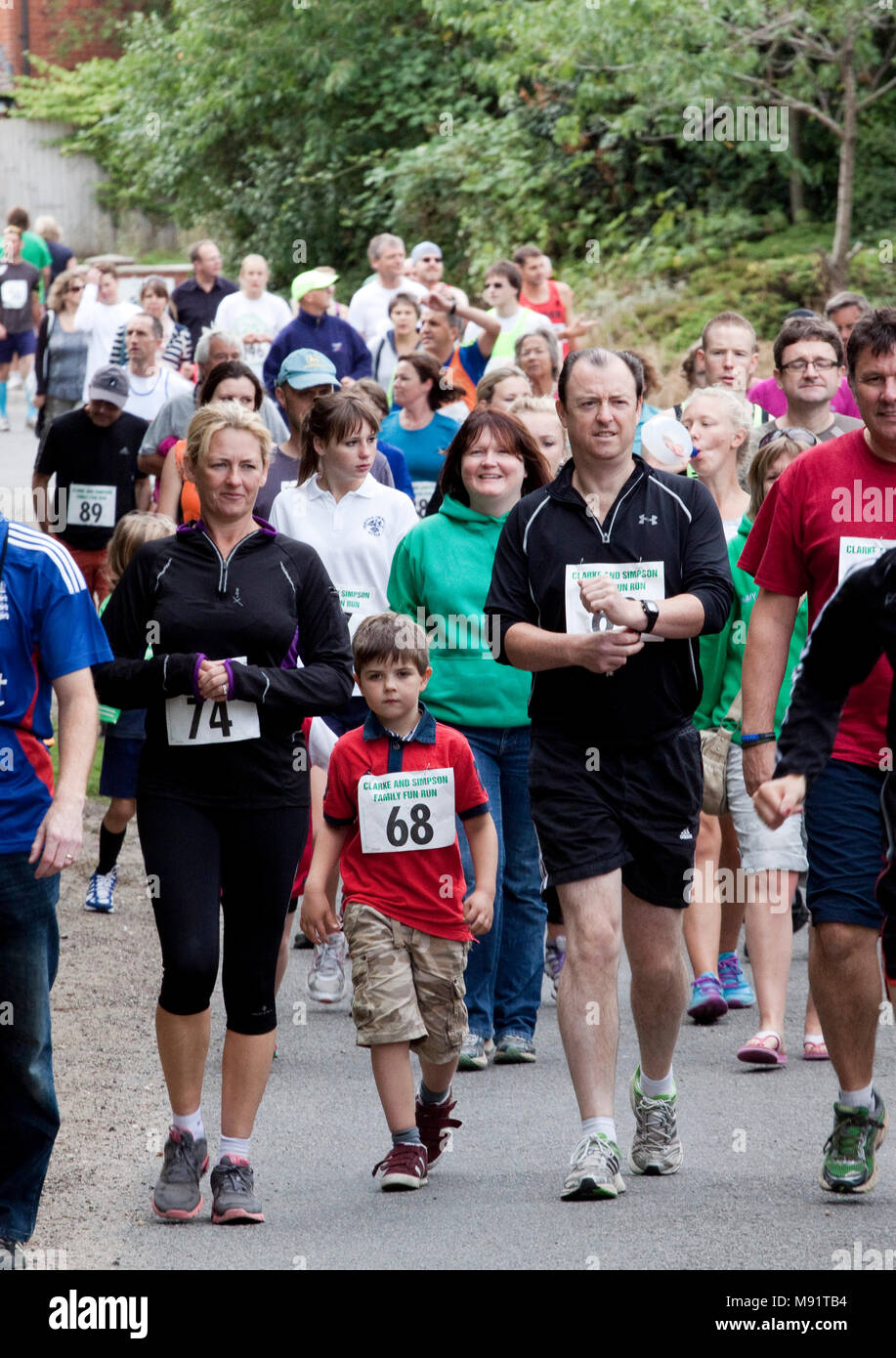Runners on a country road competing in a 10km race Stock Photo - Alamy