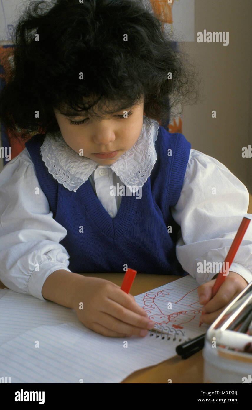 multicultural little girl in school drawing with left hand Stock Photo ...