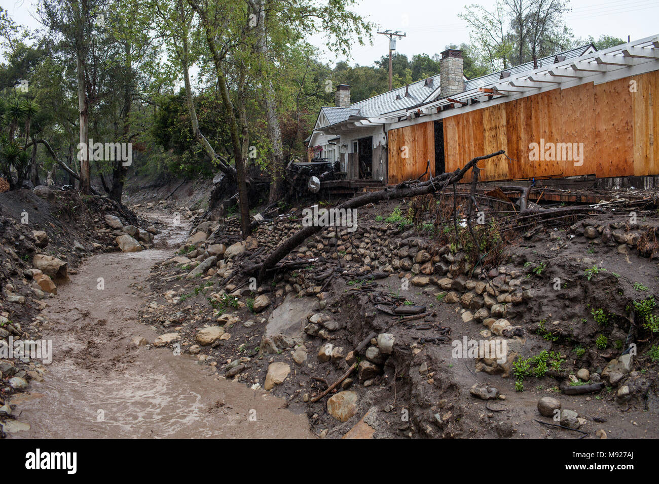 Montecito, California, USA. 21st Mar, 2018. Mud debris flows downstream ...