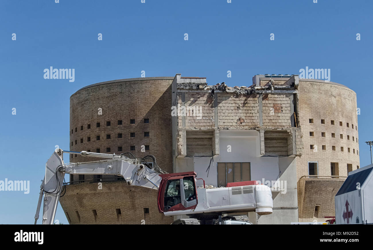 View of an excavator demolishing a building Stock Photo - Alamy