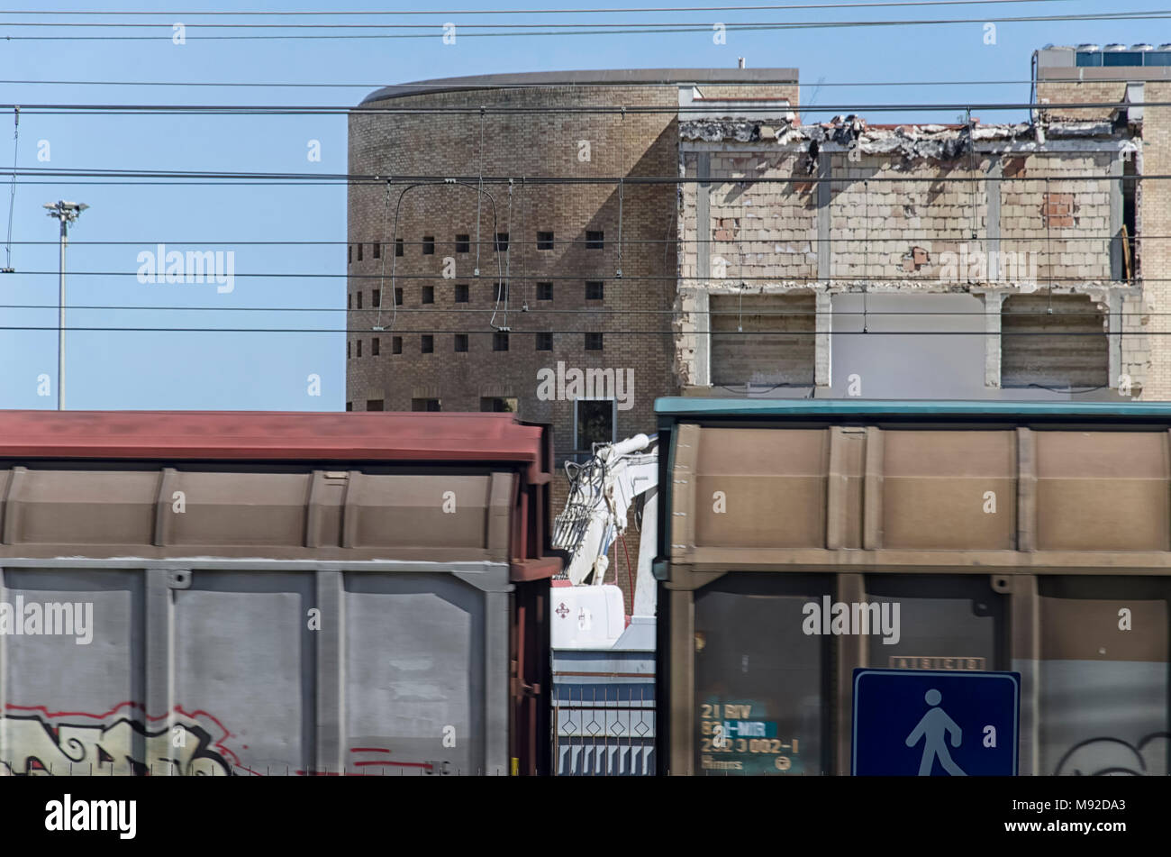 Train passing in front of a demolished building Stock Photo - Alamy