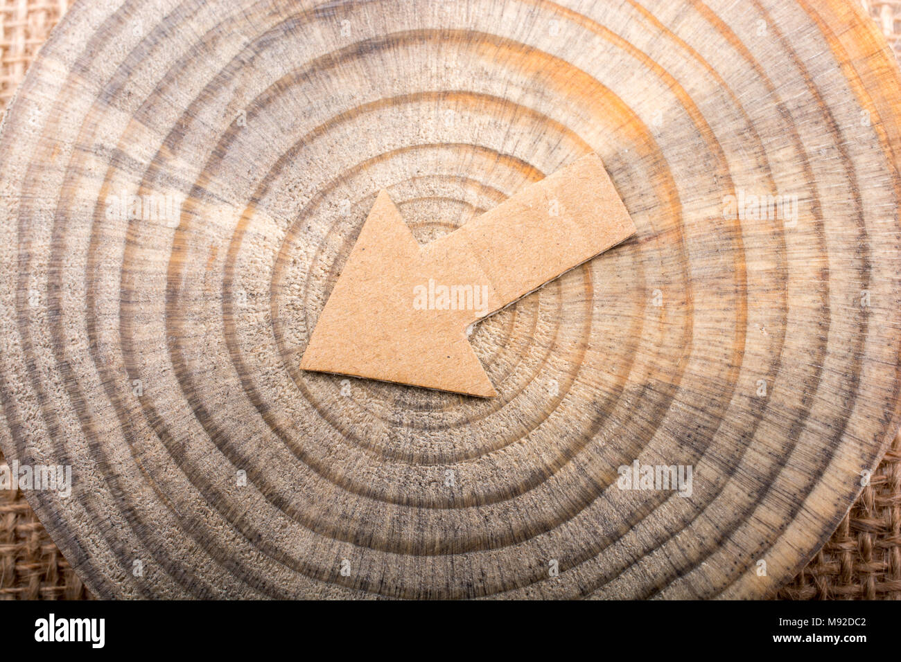 Arrow sign cut out of brown paper in view Stock Photo - Alamy