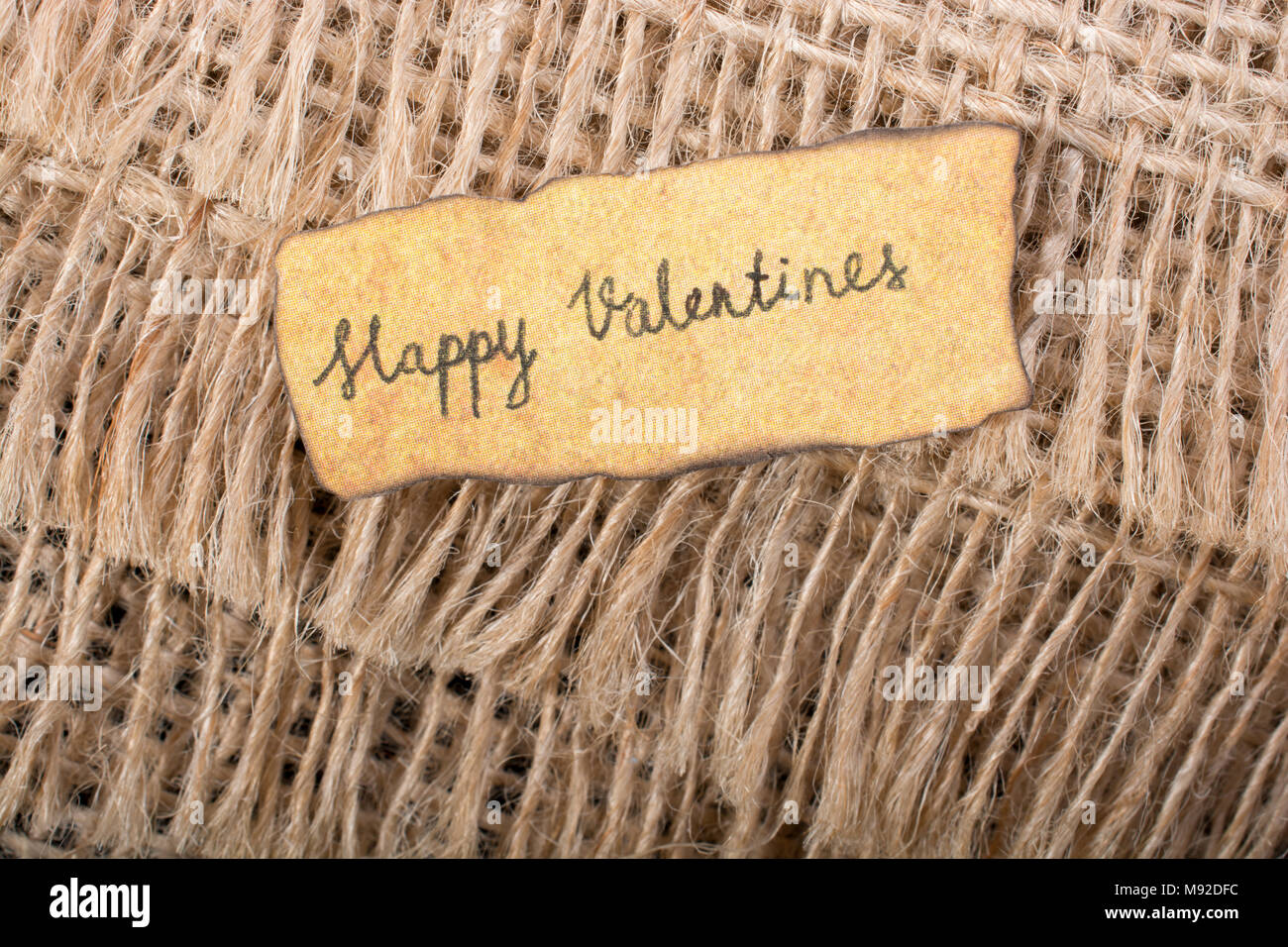 Valentine's day wording on torn paper as Love concept Stock Photo - Alamy