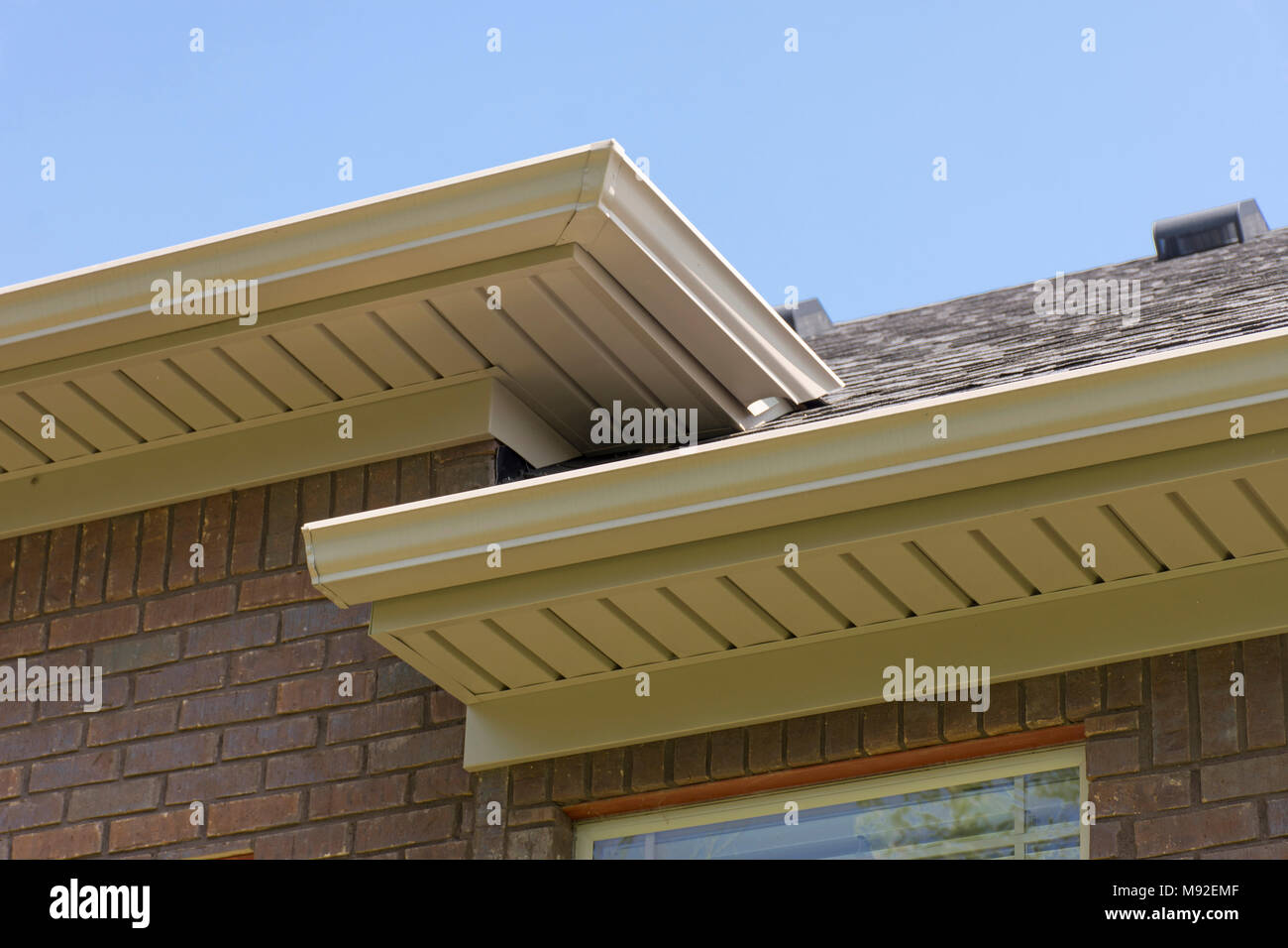 Roof showing gutters and soffit on the back of a brick house Stock ...