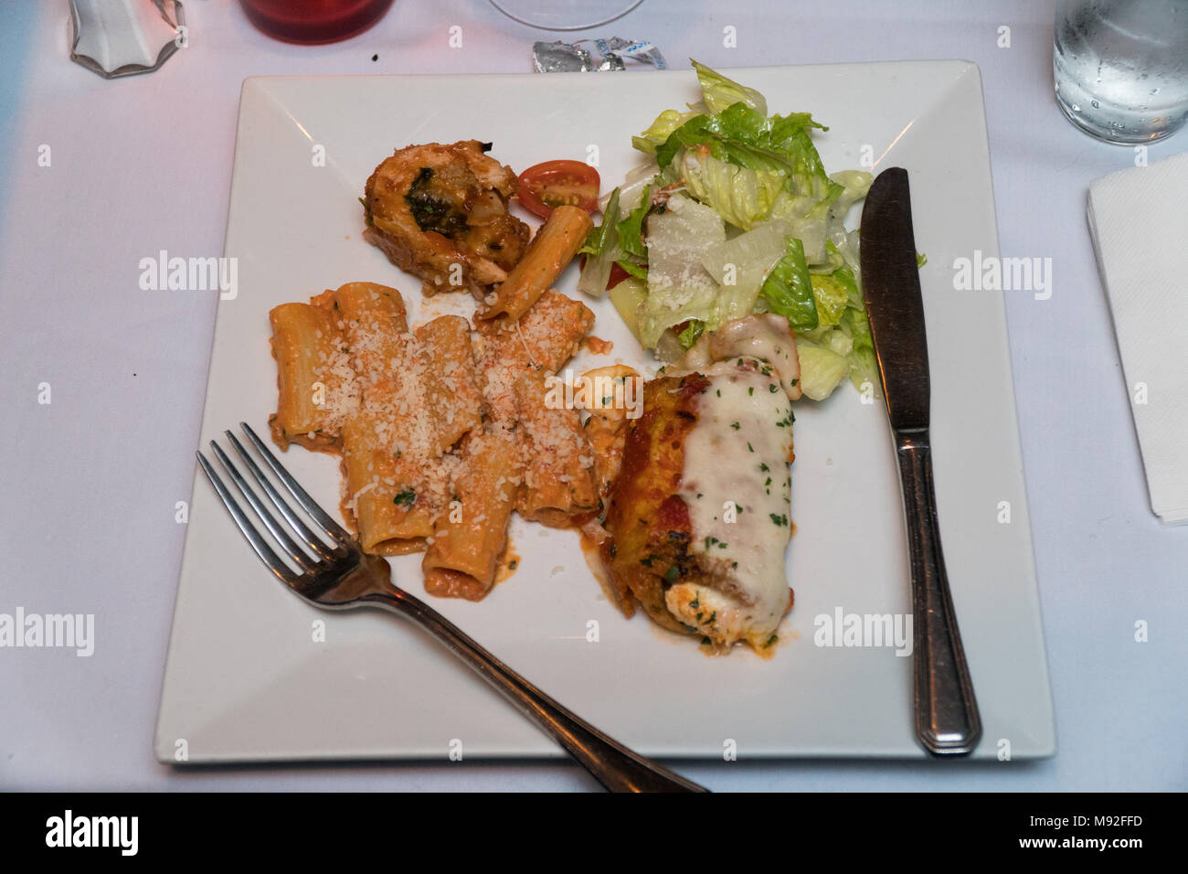 Delicious plate of italian food at upscale restaurant. Pasta, salad ...