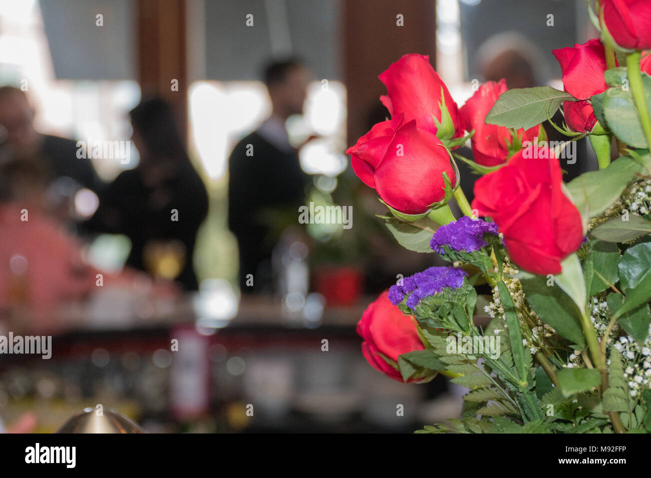 Floral decoration of red roses bring beauty to restaurant bar space on ...