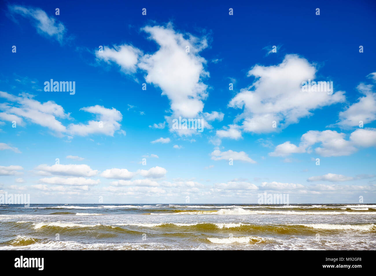 Blue sky with clouds over a sea Stock Photo - Alamy
