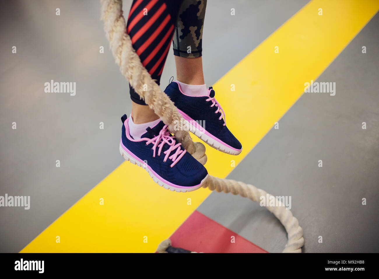 Young woman doing push-ups while legs hanging Stock Photo - Alamy