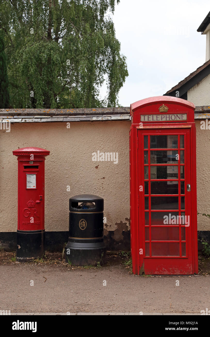 A traditional red phone booth, pillar-box and black rubbish bin ...