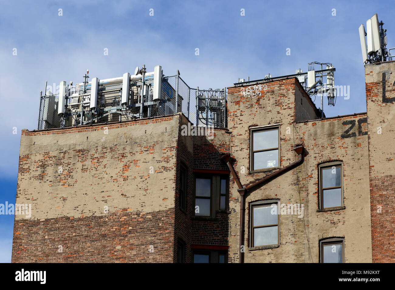 Cell towers on top of a tenement building Stock Photo - Alamy