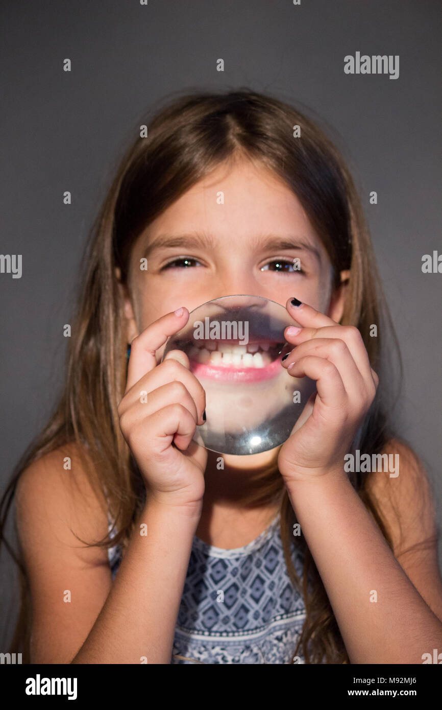 crazy little girl playing with optical eye Stock Photo - Alamy