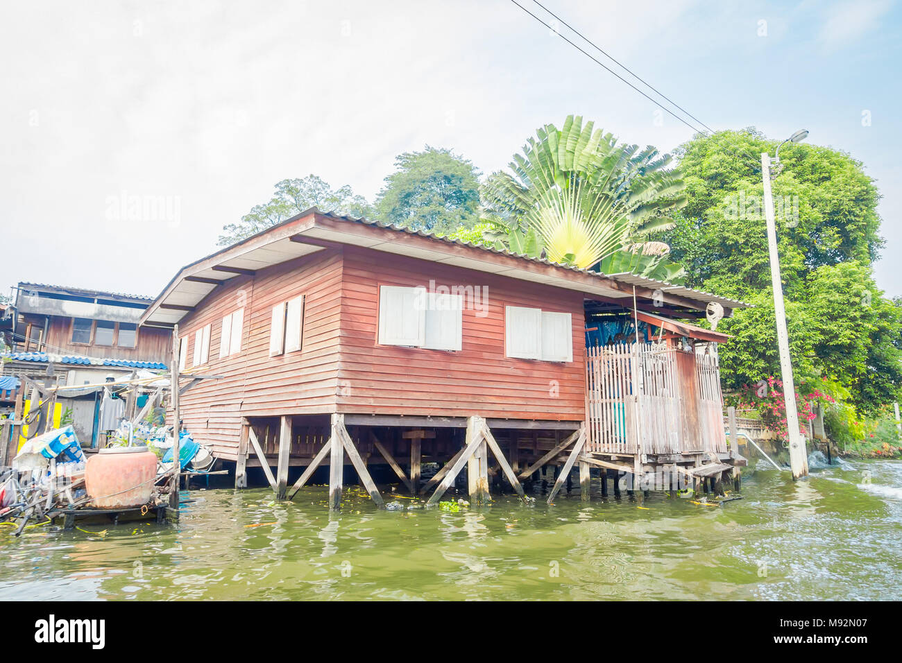 Outdoor view of floating wooden poor house located on the Chao Phraya ...