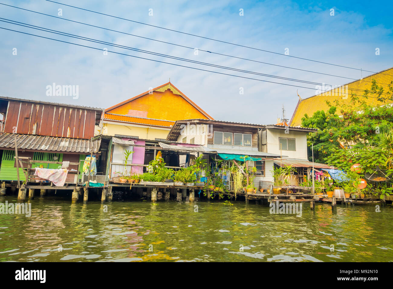 Outdoor view of floating wooden poor house located on the Chao Phraya ...