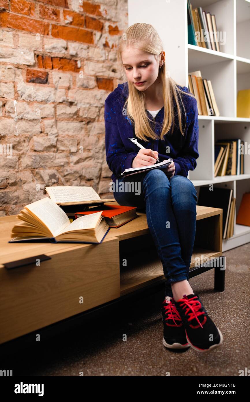 Teenage girl in a library Stock Photo - Alamy