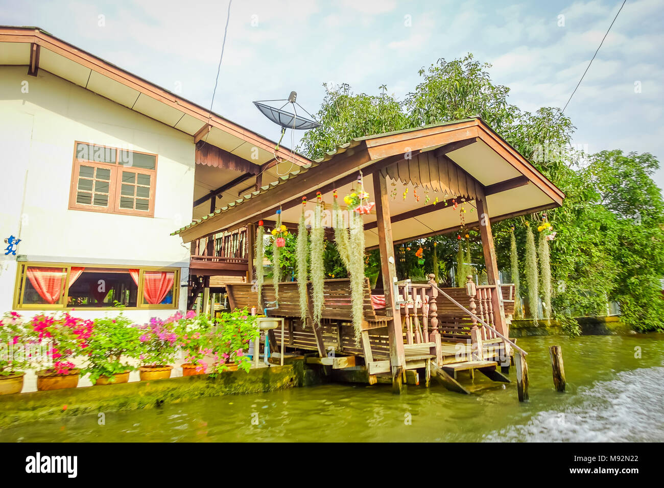 Outdoor view of gorgeous floating wooden house on the Chao Phraya river ...
