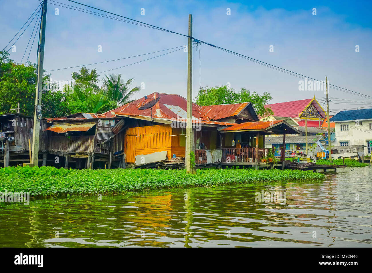 Floating poor wooden house at the riverside on the Chao Phraya river ...