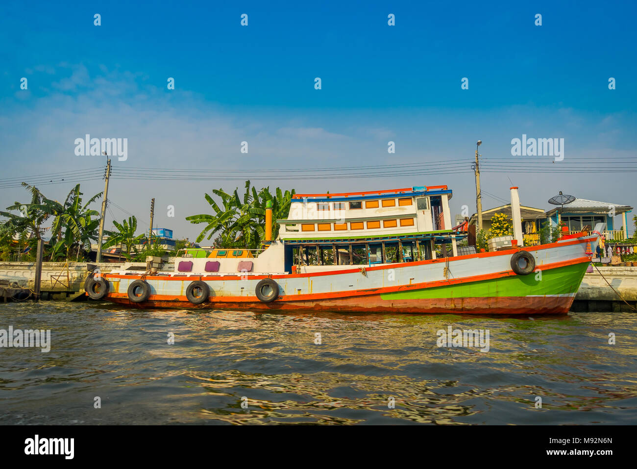 Outdoor view of boat at riverside in the water in Bangkok yai canal or ...