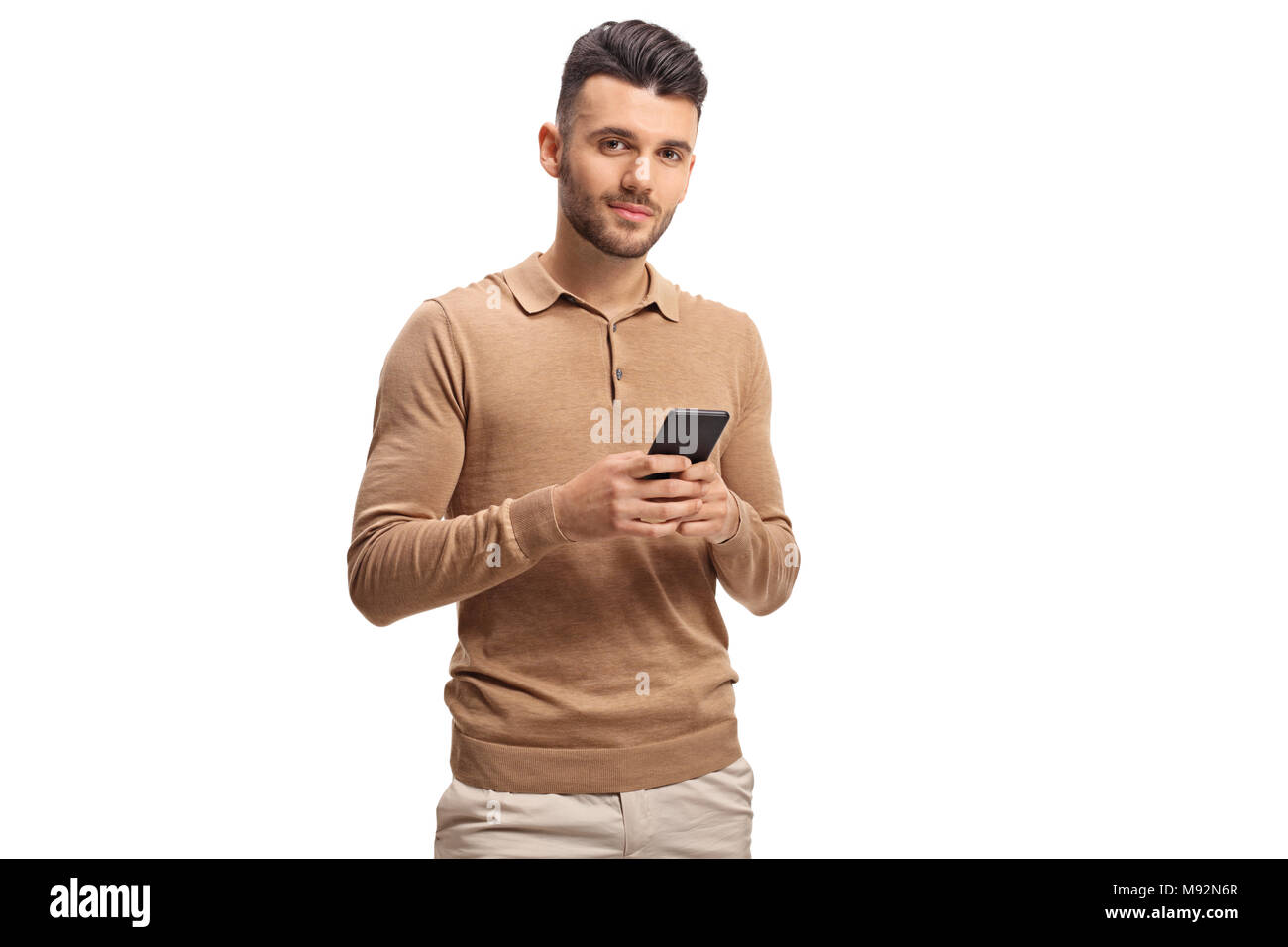 Young man with a phone isolated on white background Stock Photo - Alamy