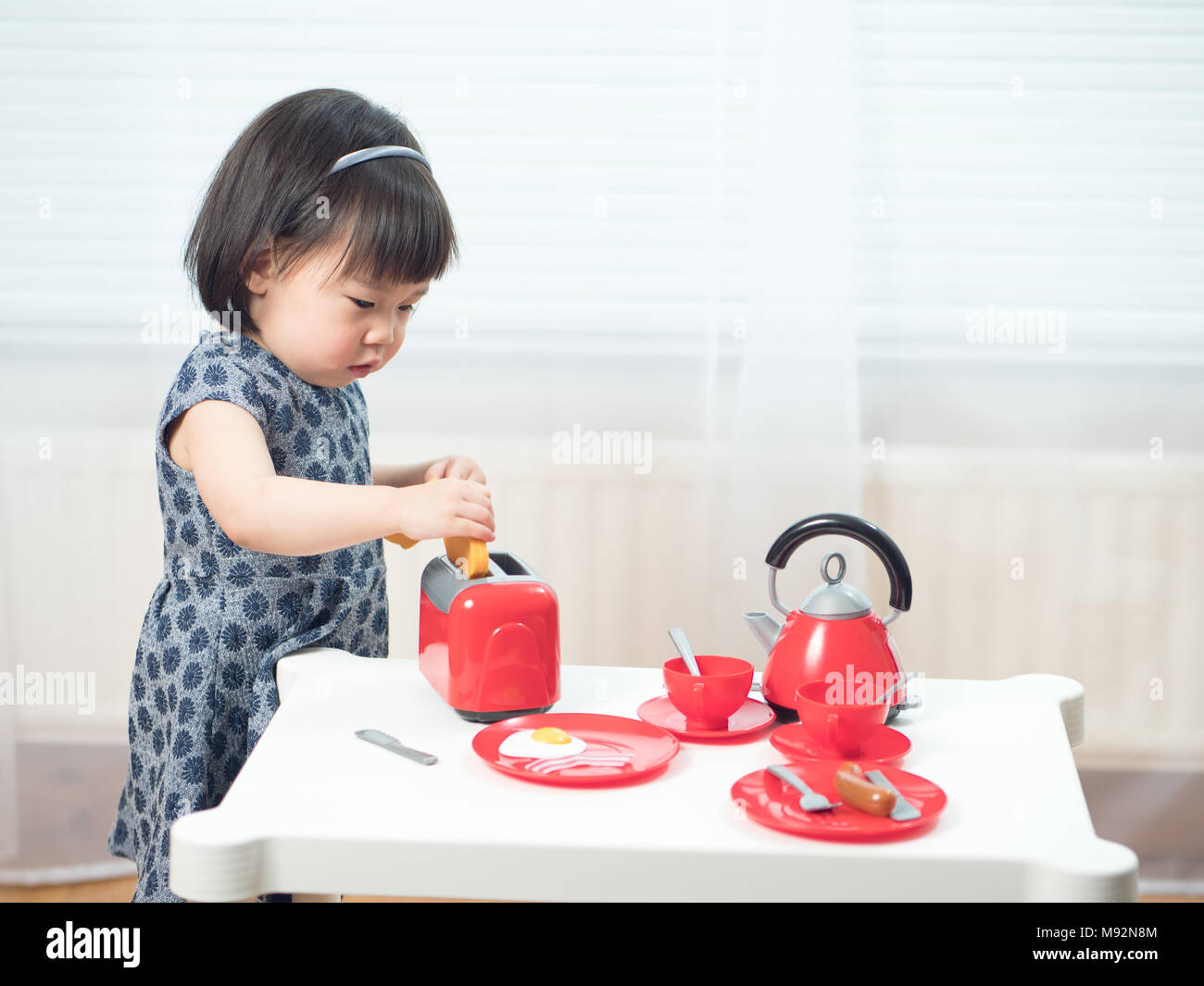 baby girl pretend play food toy Stock Photo - Alamy