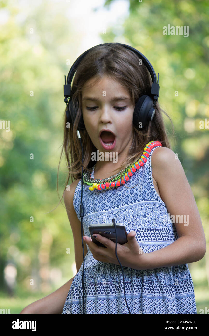 sweet little girl with headset Stock Photo - Alamy