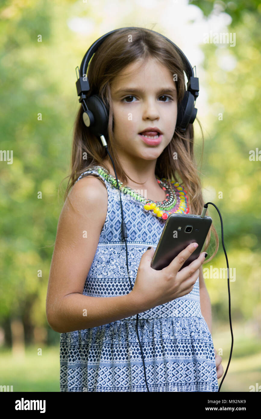 little girl using telephone and headset Stock Photo - Alamy