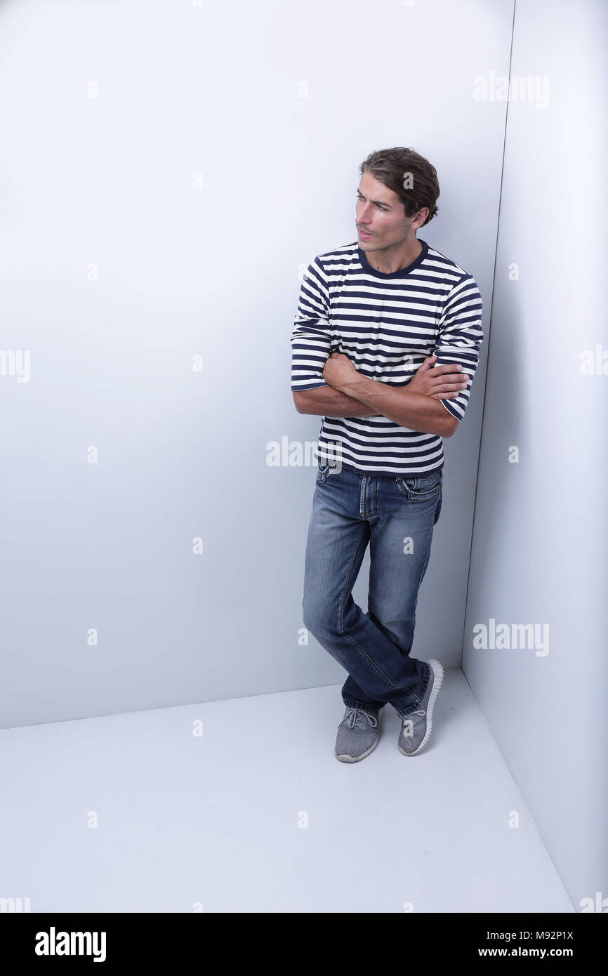 thoughtful man standing in the corner Stock Photo - Alamy