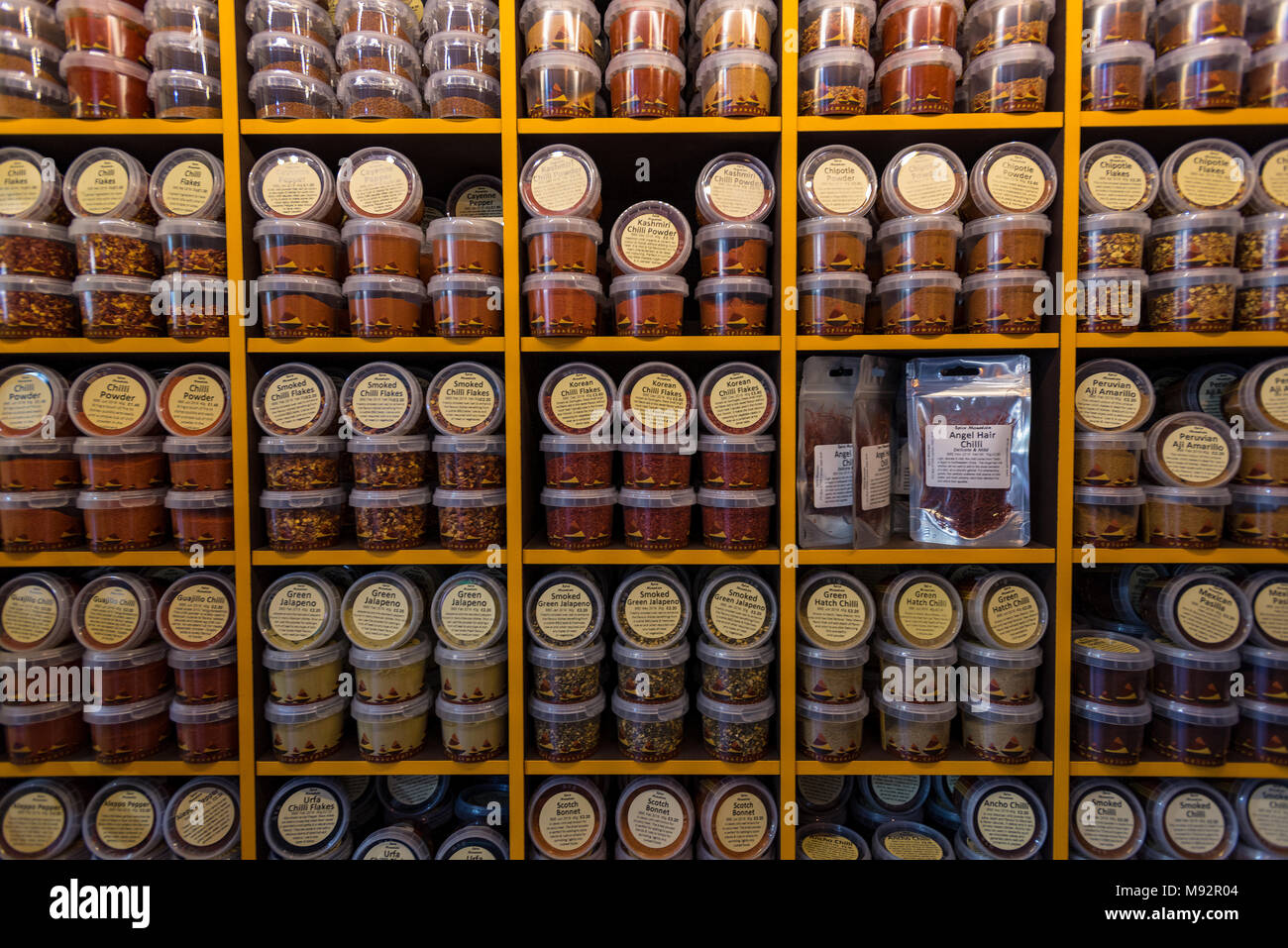 a large quantity of spices on display on a big rack at a spice and herb ...
