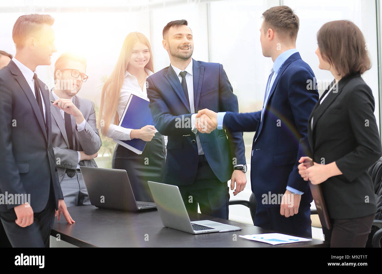Friendly handshake between colleagues hi-res stock photography and ...