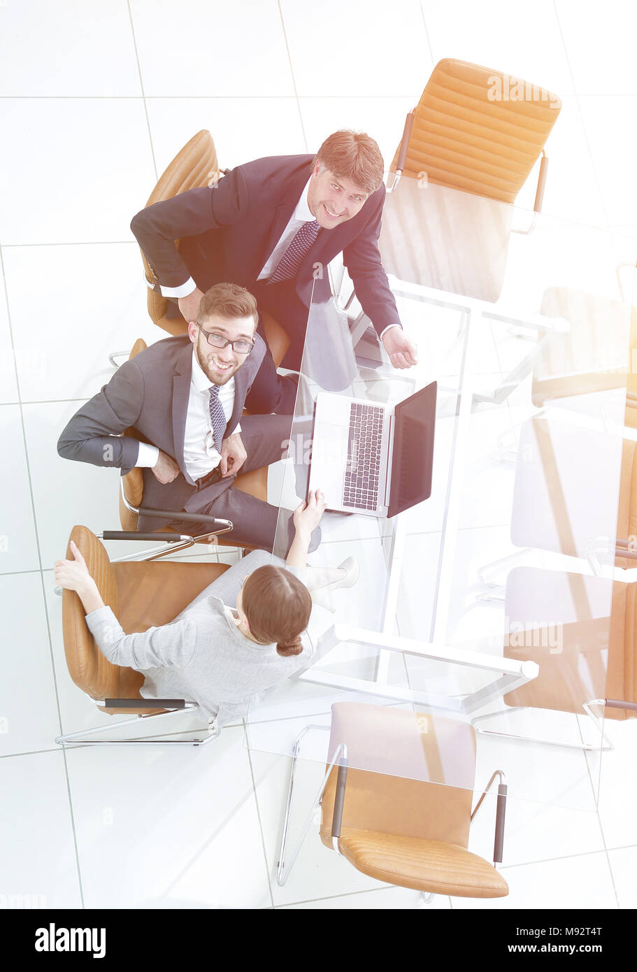 Top view .employees sitting at the desk and looking up Stock Photo - Alamy