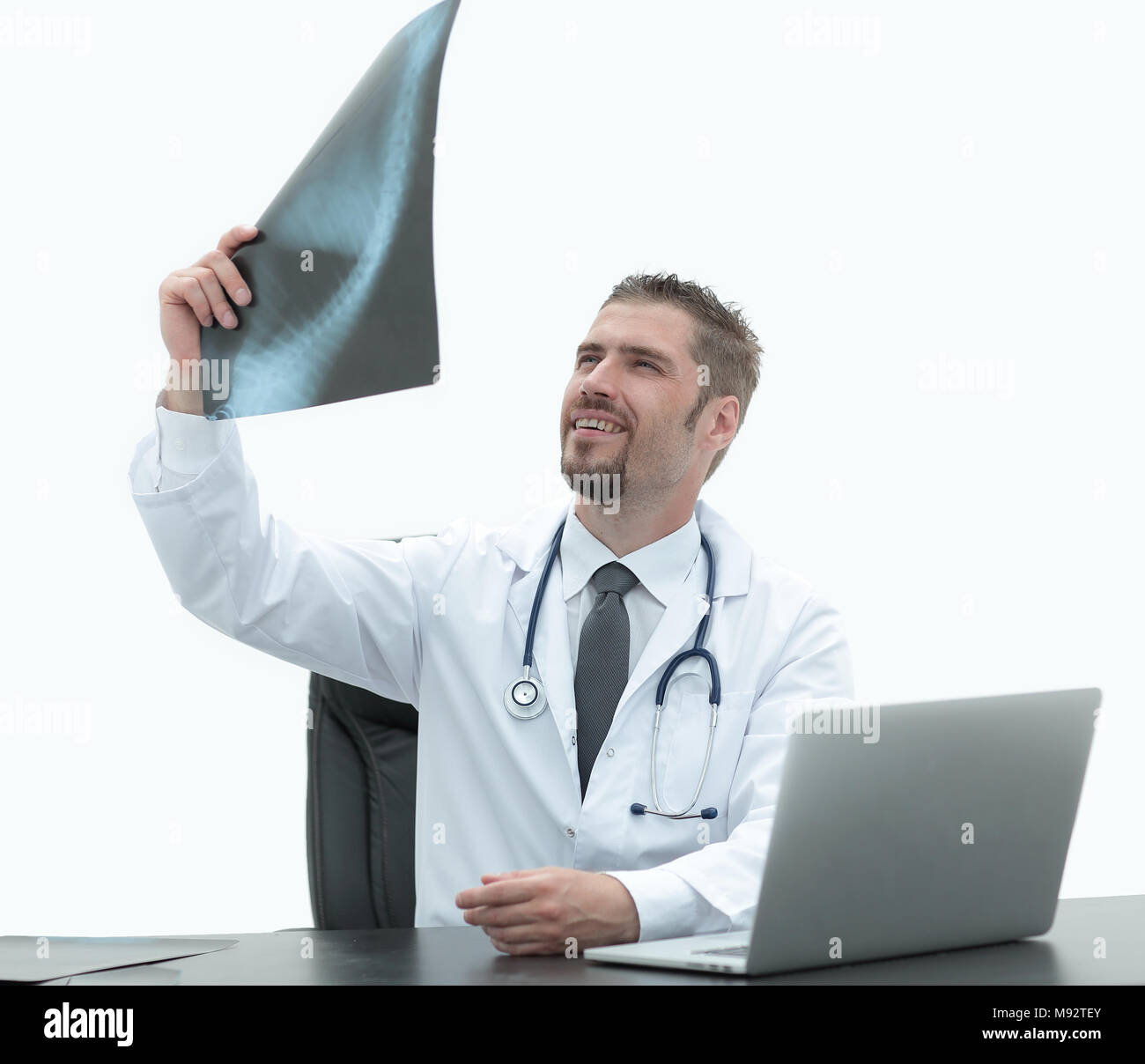 doctor examines an x-ray,sitting behind a Desk Stock Photo - Alamy