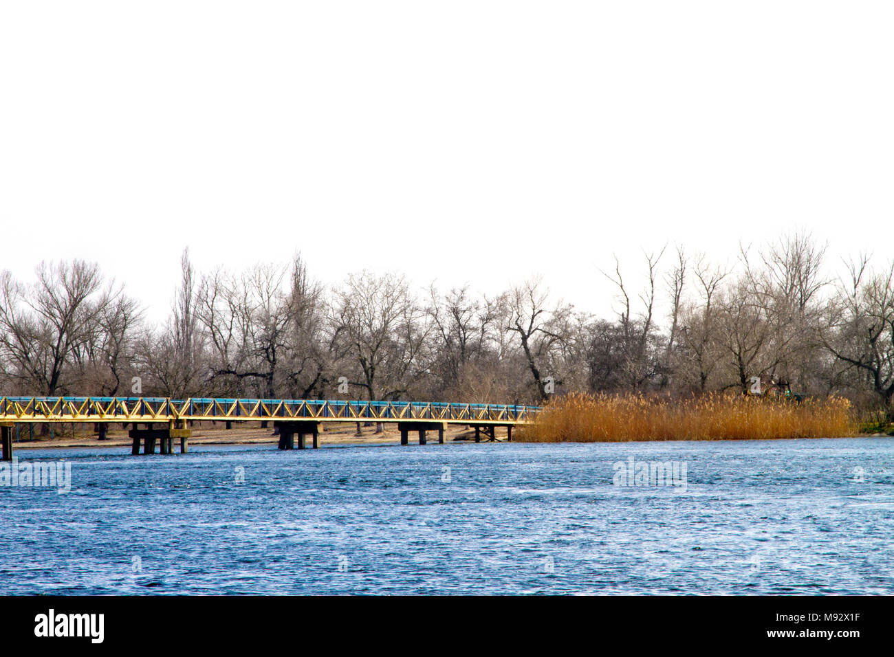 image of a pedestrian bridge across a large river Stock Photo - Alamy
