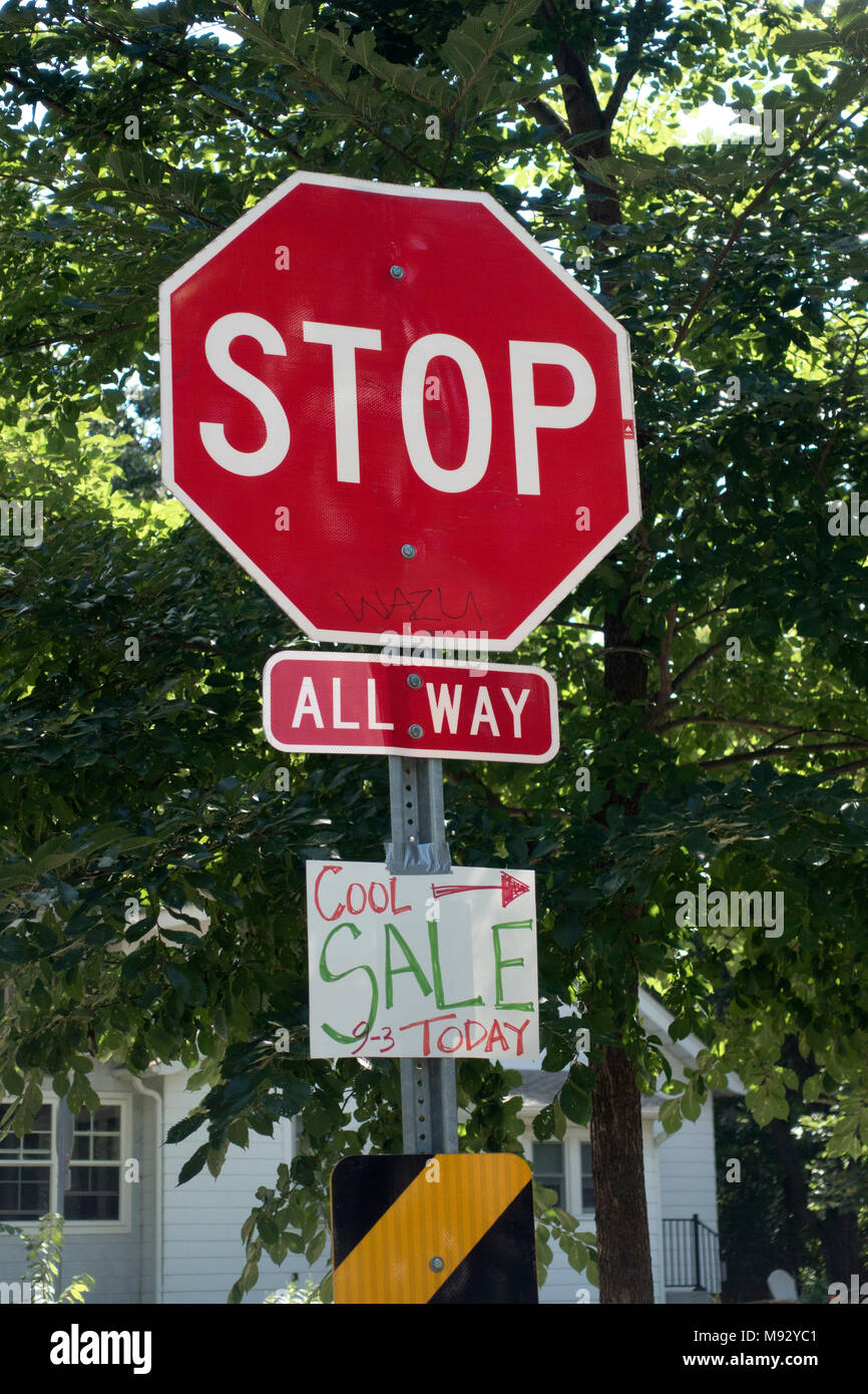 Stop sign pole with an attached sign with arrow advertising a ...