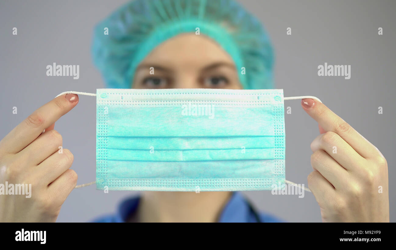 Hospital doctor showing protective mask, examining patient procedure ...
