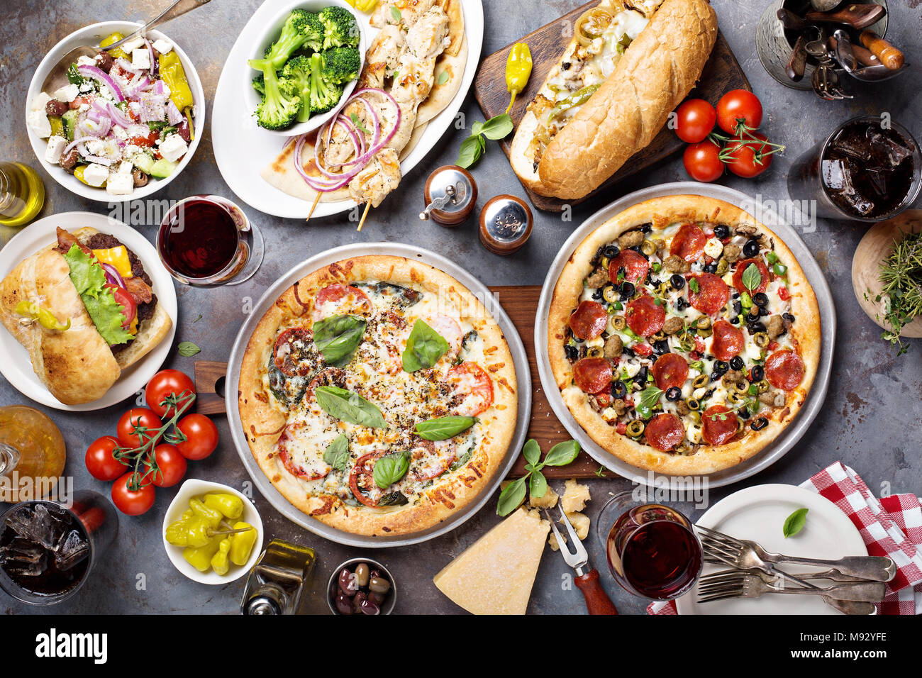 Big dinner with pizza, salad and sandwiches overhead view Stock Photo ...