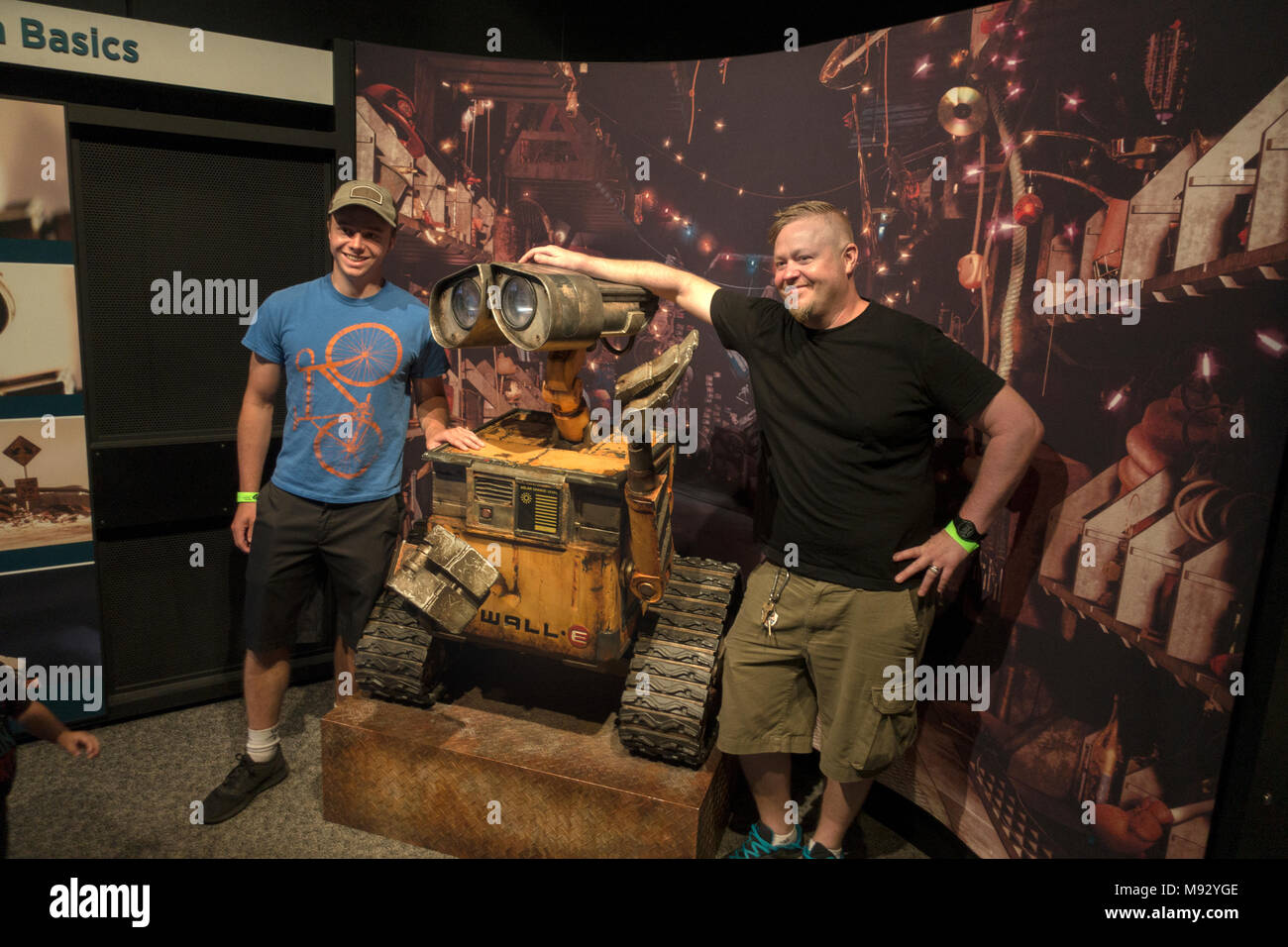 Uncle showing his nephew WALL·E the waste-collecting robot from a movie ...