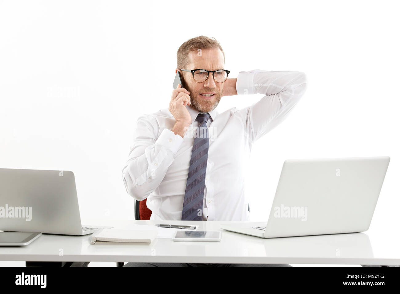 Middle aged financial director businessman using his mobile phone and ...