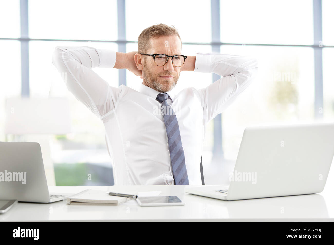 Stressed middle aged financial businessman sitting at desk and working ...
