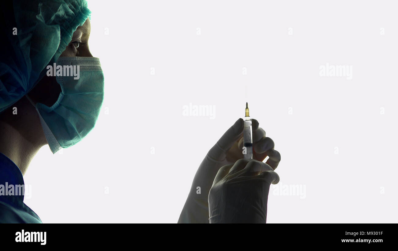 Nurse anesthetist with syringe in hand, injection before surgery ...